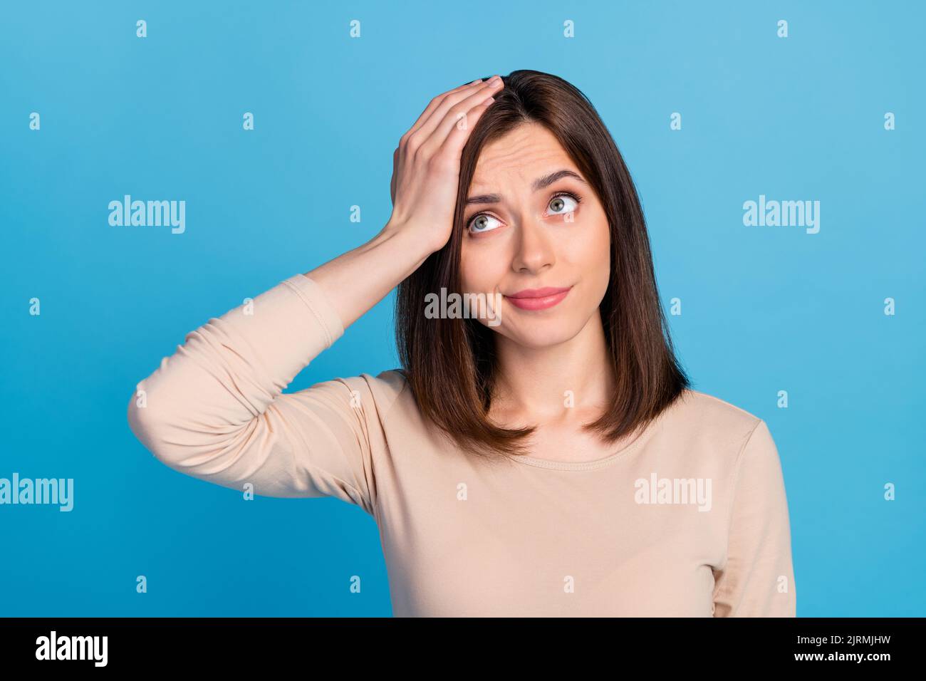 Portrait of unsatisfied person arm touch head look empty space isolated ...