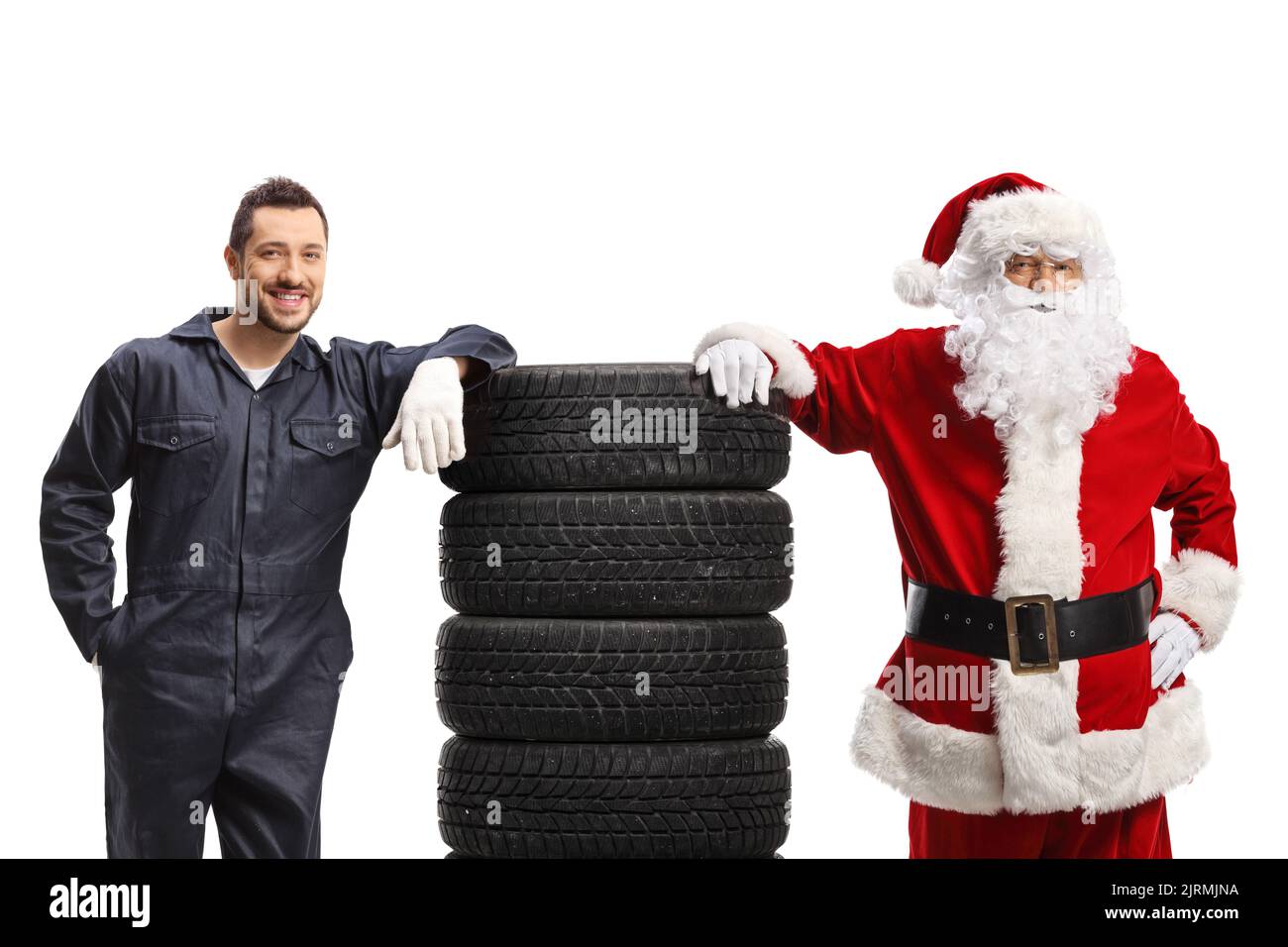 Car mechanic and Santa Claus posing with a pile of tires isolated on ...