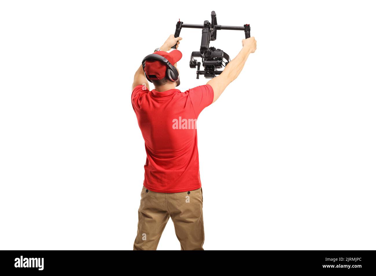 Rear view shot of a camera operator using a camera gimbal stabilizer ...