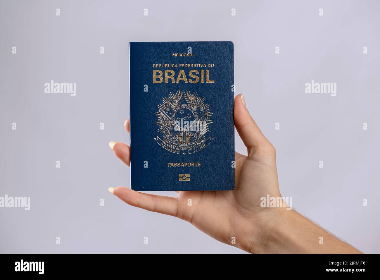 Brazilian passport in a hand with white background Stock Photo - Alamy