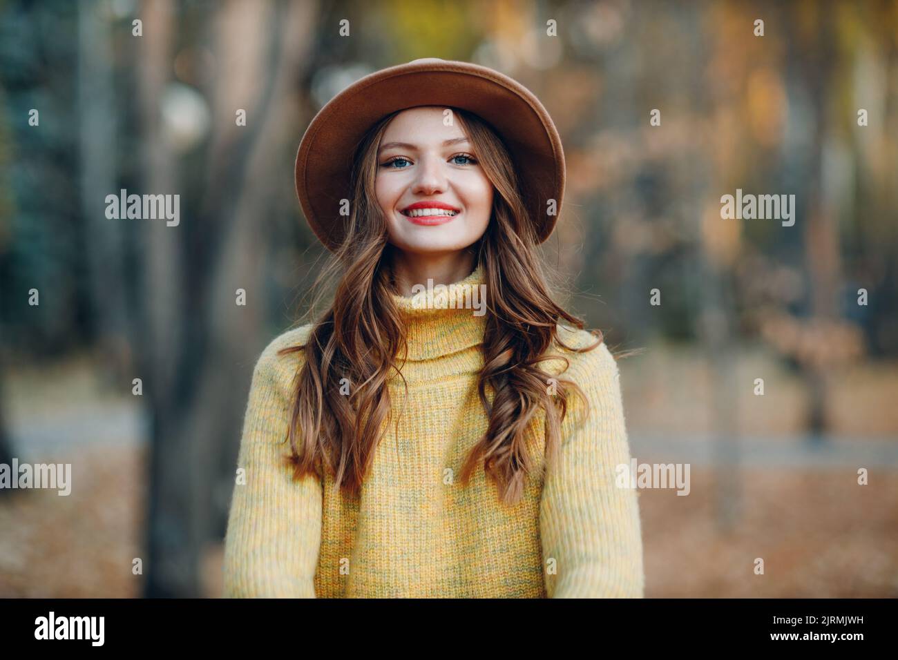 Young woman model in autumn park with yellow foliage maple leaves. Fall ...