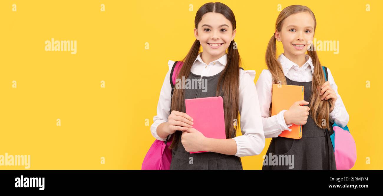 School girls friends. Happy kids in fomal uniforms with study books ...