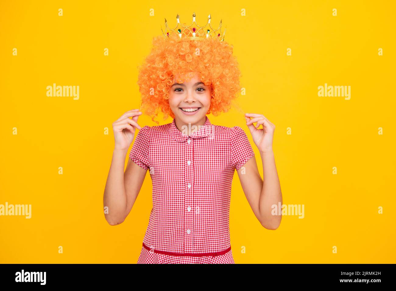 Portrait of ambitious teenage girl in wig with crown, feeling princess ...