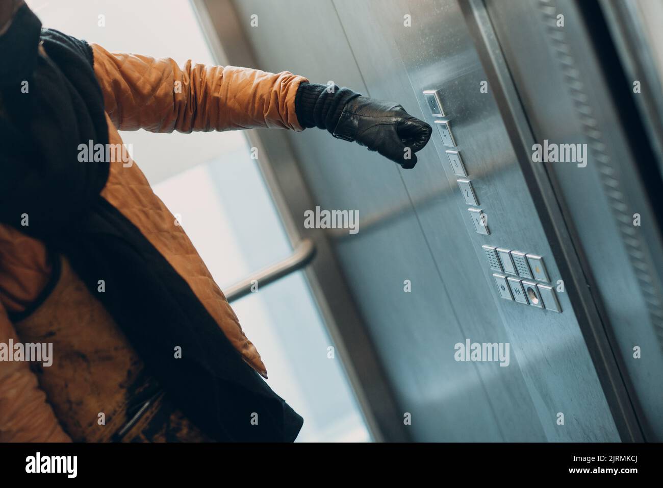 Close up of forefinger pressing the button elevator during coronavirus ...