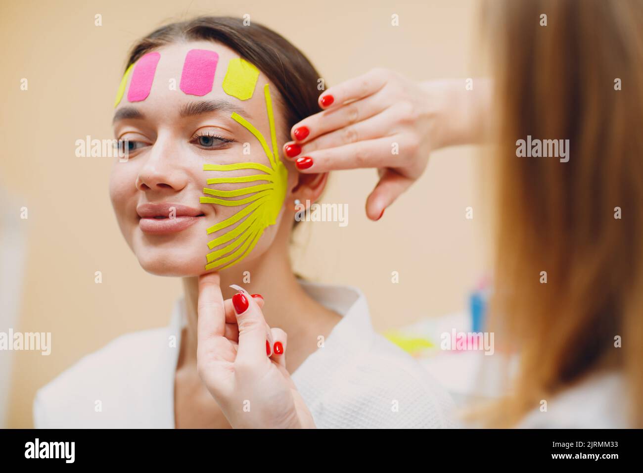 Beautiful woman applying tape lifting treatment procedure on face Stock ...
