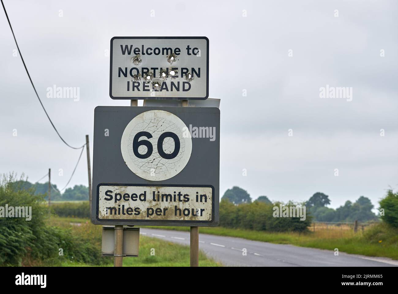 A welcome to Northern Ireland sign riddled with large bullet holes ...