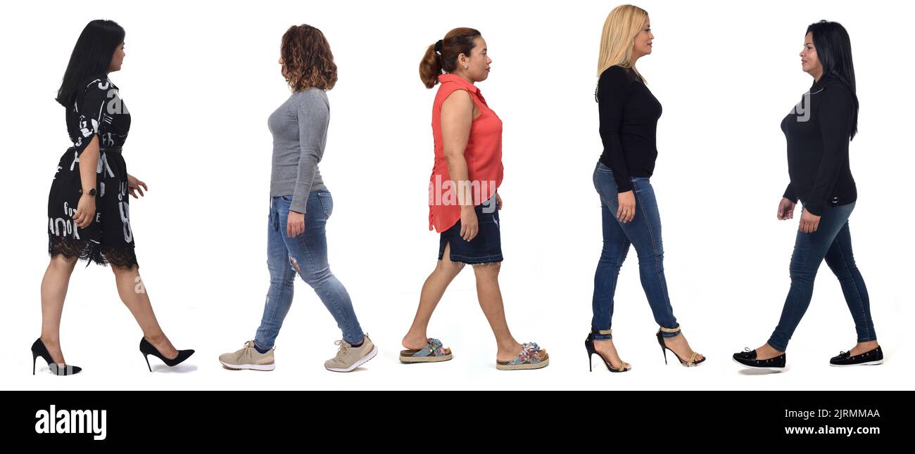 side view of a group of woman walking on white background Stock Photo ...