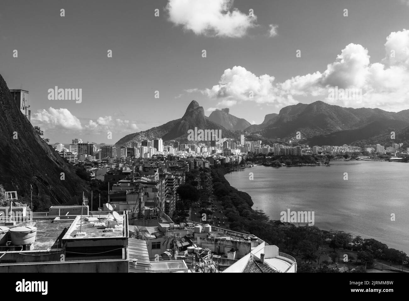 A grayscale of the coastline tropical city buildings and mountains of ...