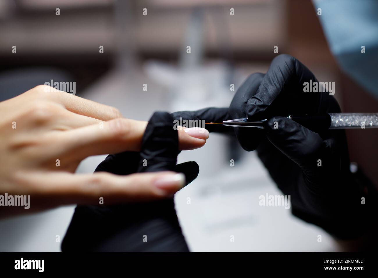 Manicure process female hands finger nails polish. Beautician in gloves ...