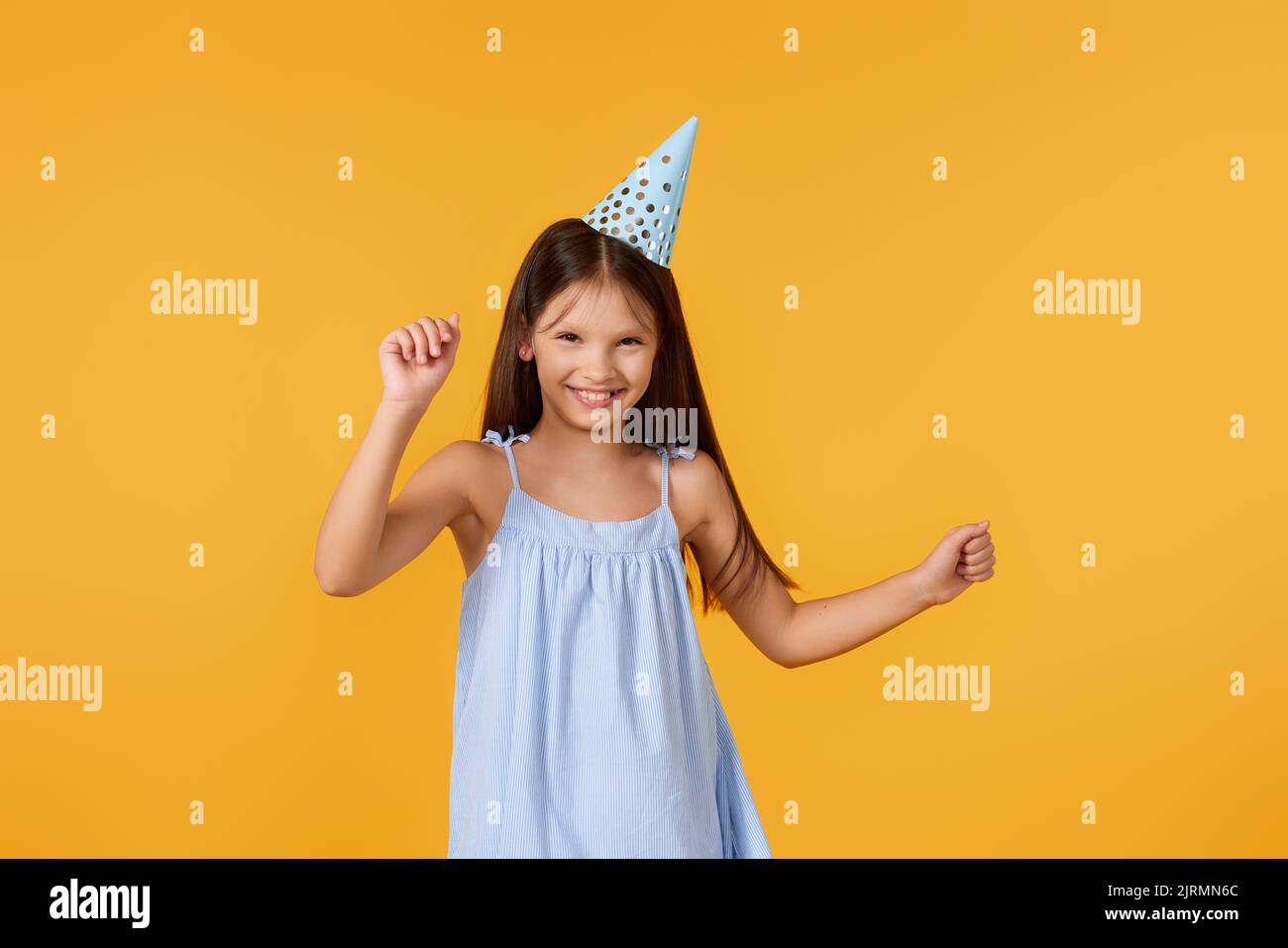 happy birthday child girl dancing on yellow background Stock Photo - Alamy