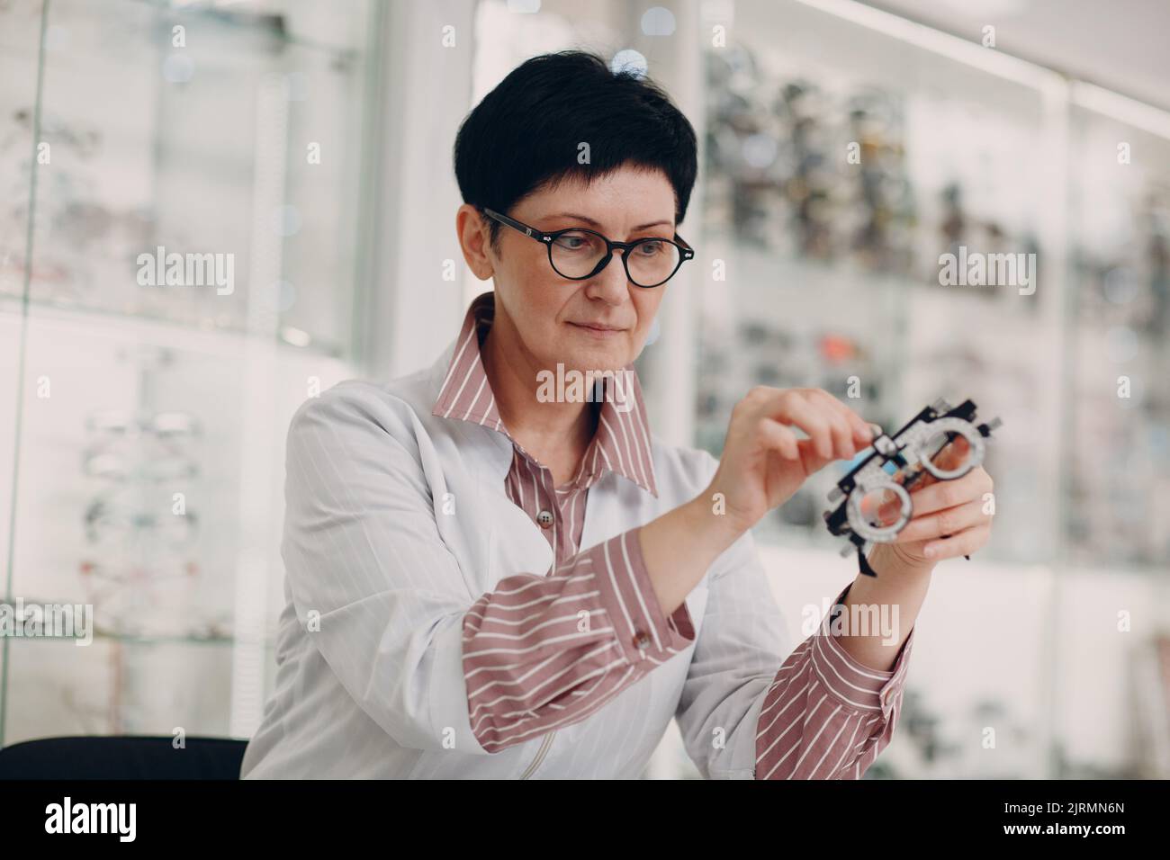 Happy Optician Choosing Eyeglasses, female optometrist with glasses ...