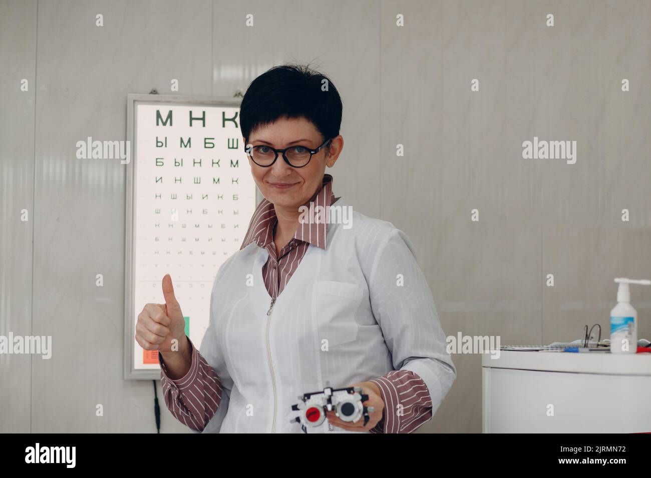 Doctor optician with letter chart for eye vision test check Stock Photo ...