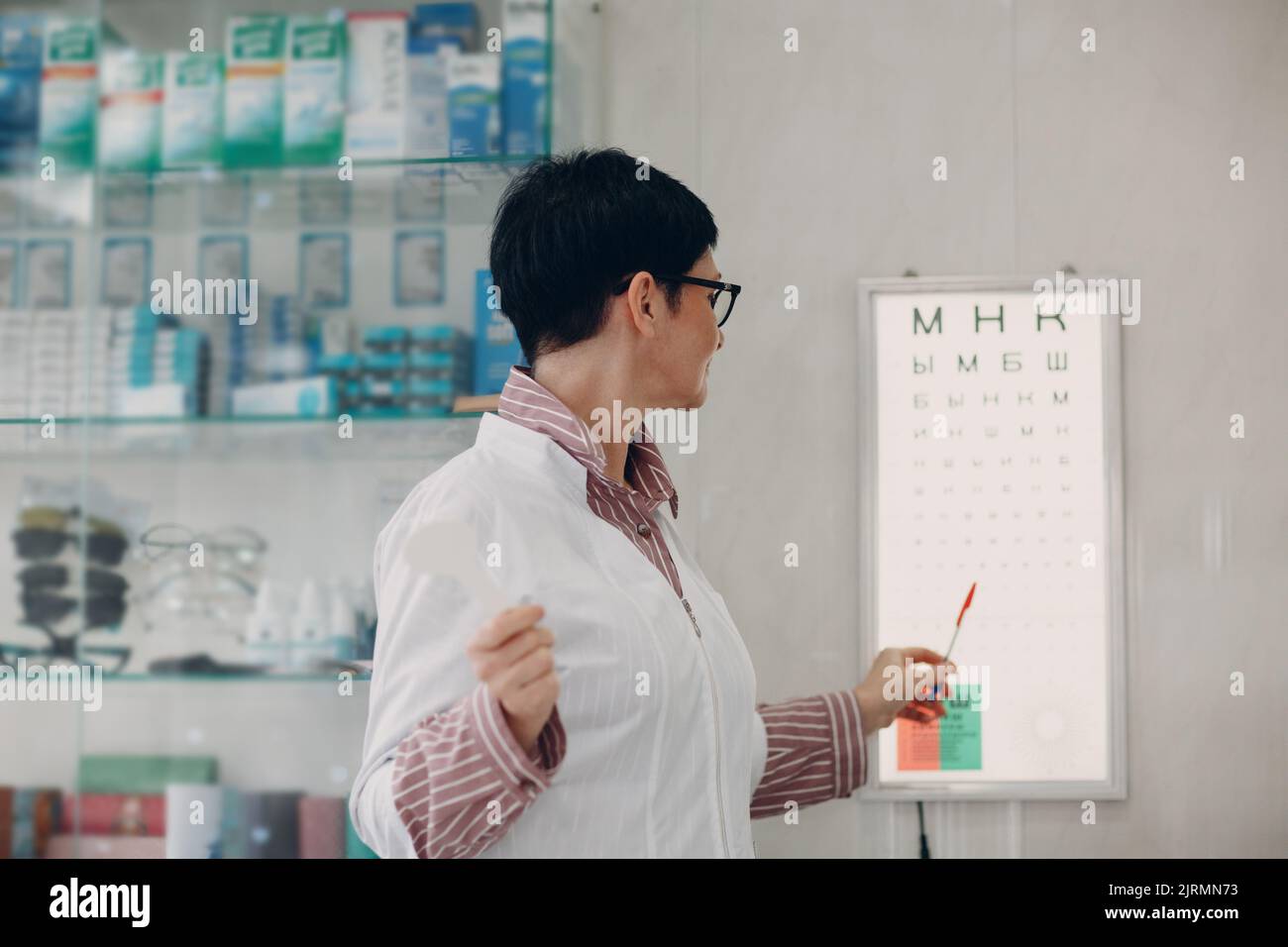 Doctor optician with letter chart for eye vision test check Stock Photo ...