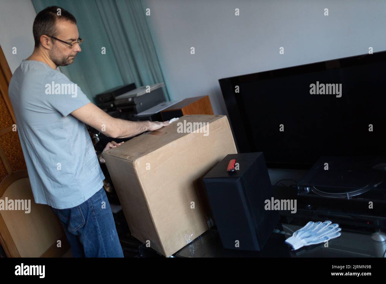 Adult man small business owner packing order box package shipping to ...