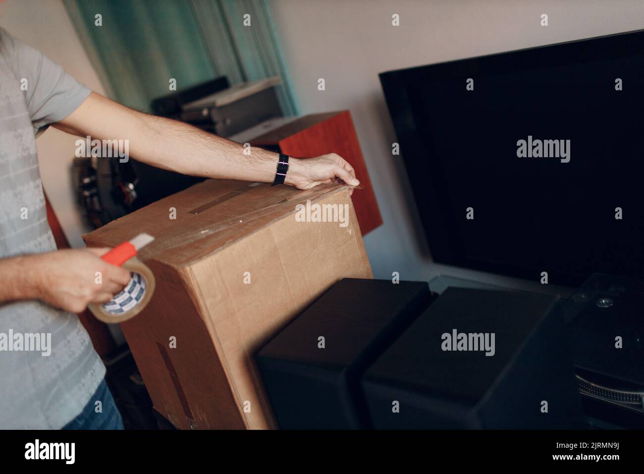 Adult man small business owner packing order box package shipping to ...