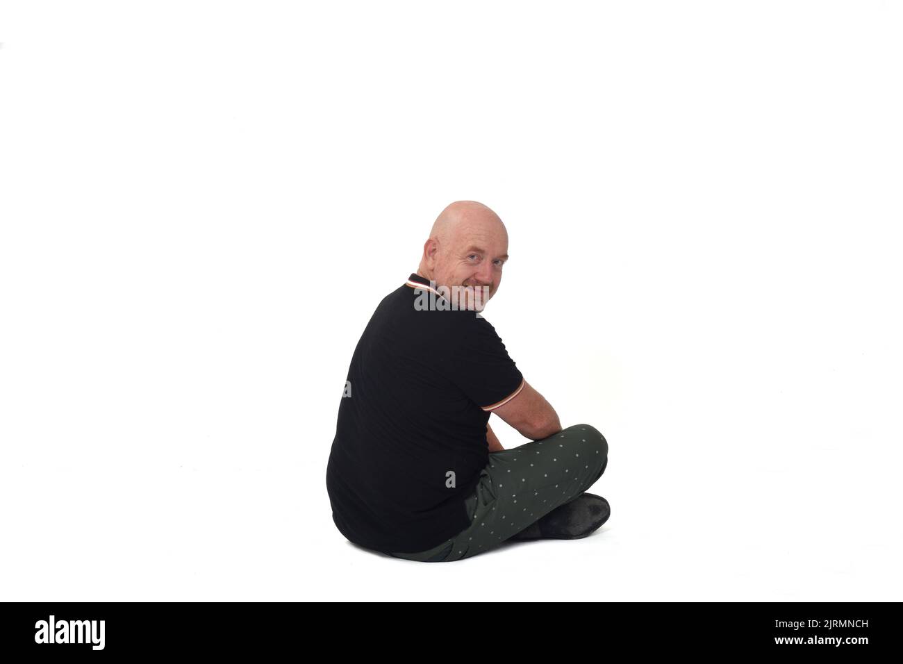 view of man sitting on floor looking at camera on white backgound Stock ...