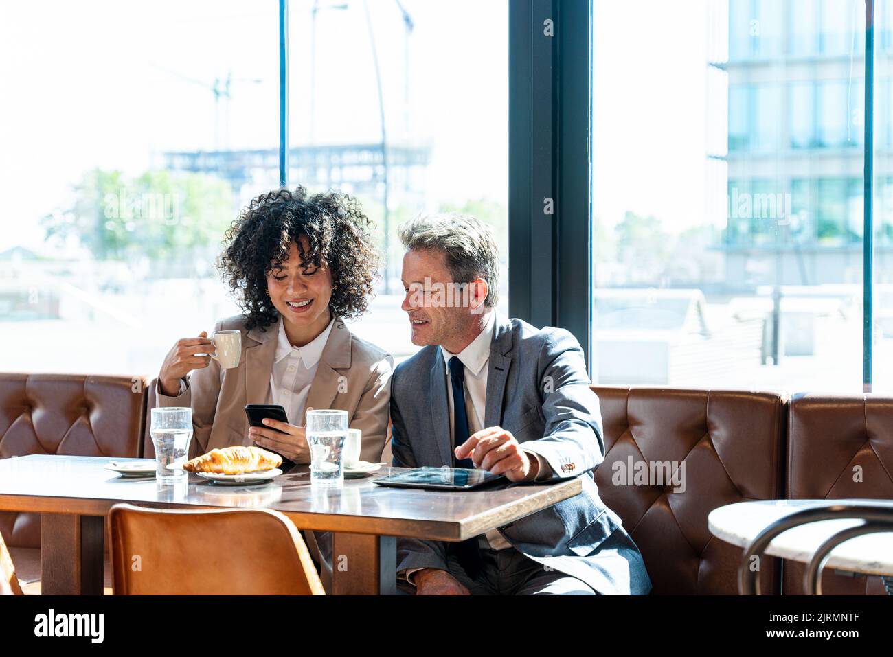 Senior businessman and beautiful hispanic businesswoman meeting in a ...