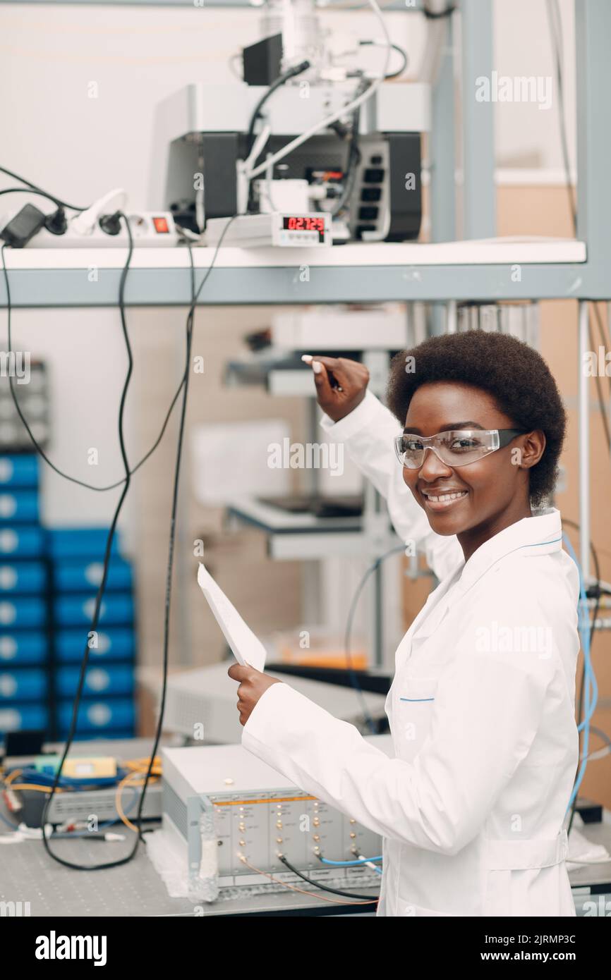 Scientist african american woman working in laboratory with electronic ...