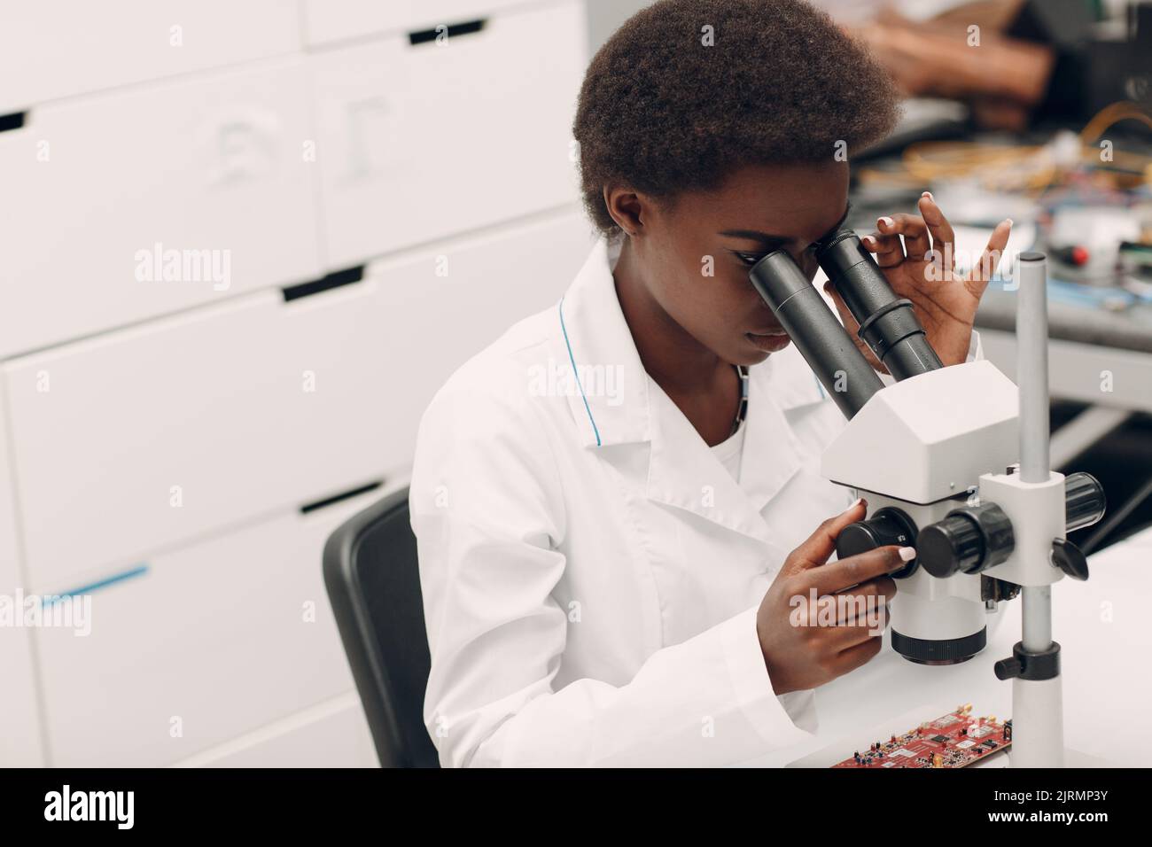 Scientist african american woman working in laboratory with electronic ...