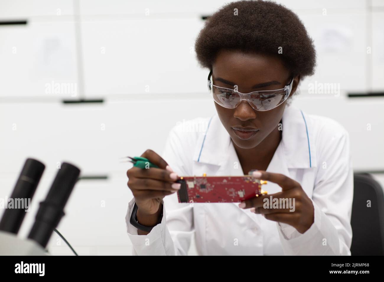 Scientist african american woman working in laboratory with electronic ...