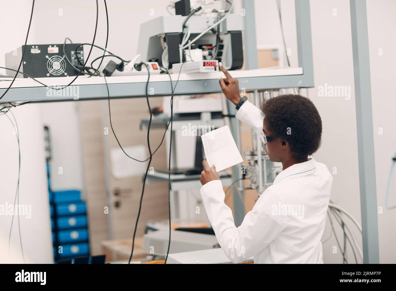 Scientist african american woman working in laboratory with electronic ...