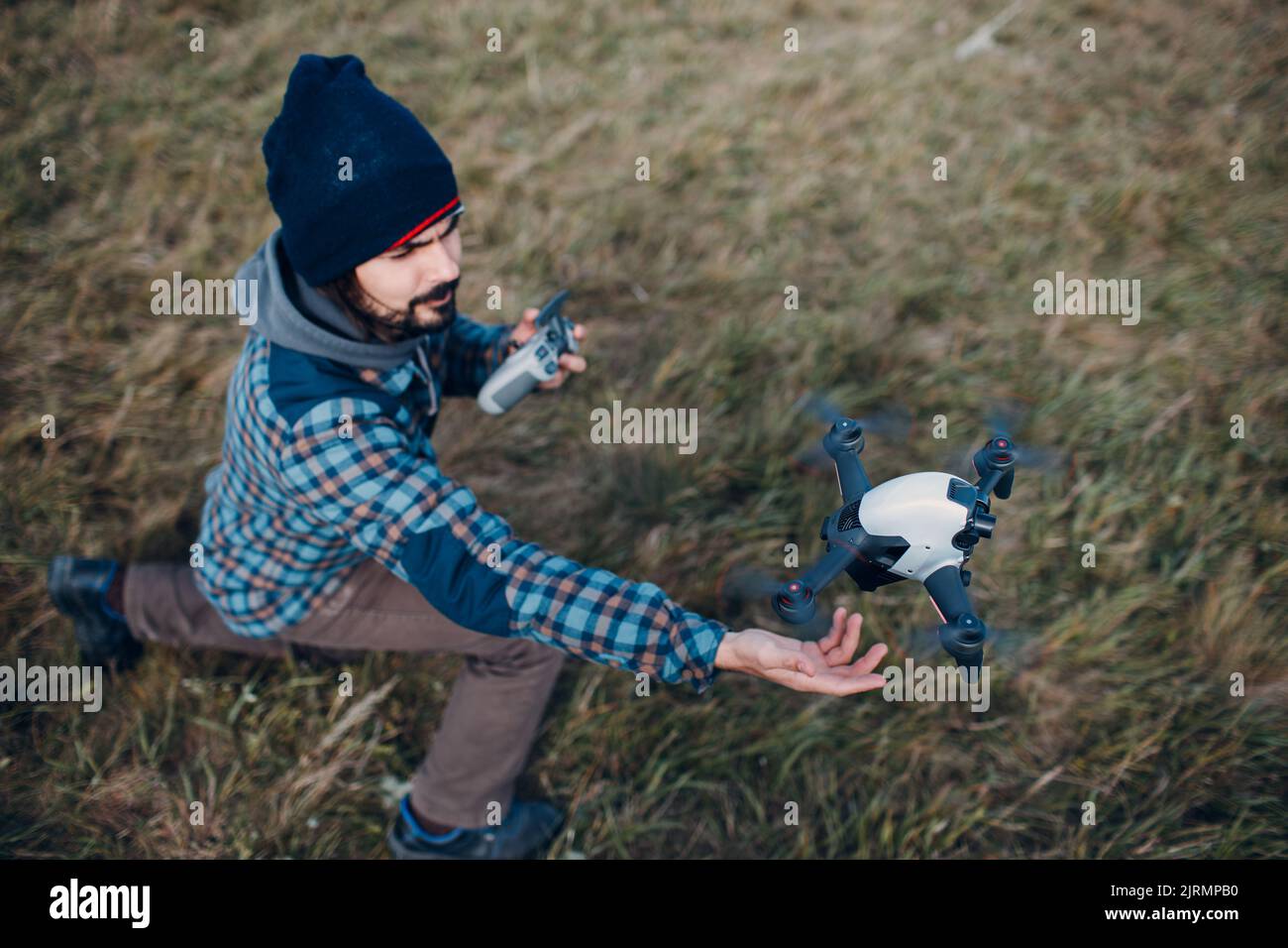 Man pilot Launches quadcopter drone from hand to sky flight Stock Photo ...