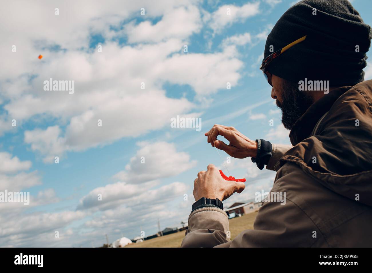 Young man flying a kite against blue sky Stock Photo - Alamy