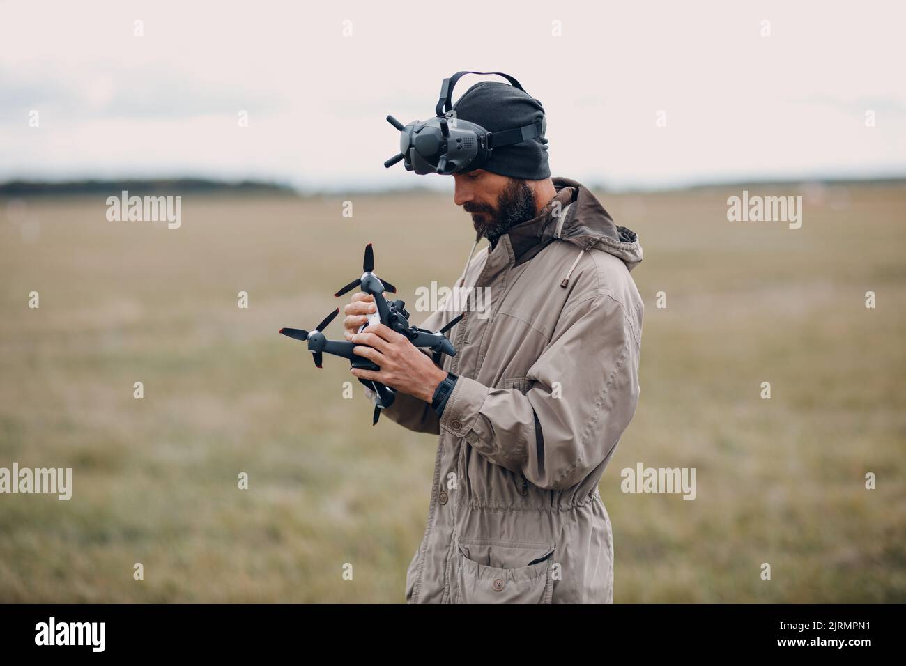 Man controlling fpv quadcopter drone for aerial photography and ...