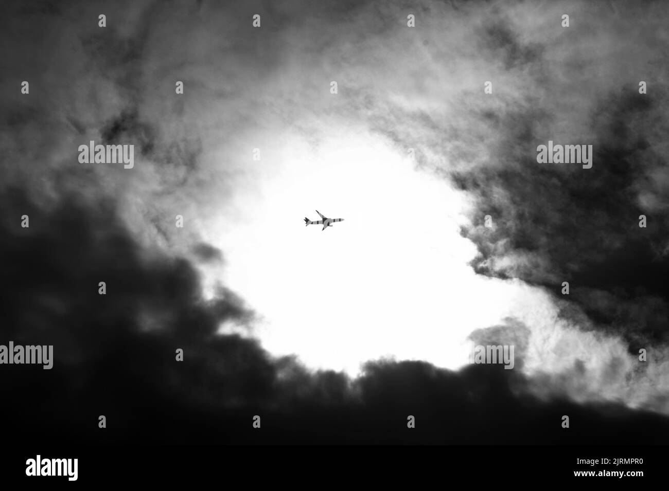 An air plane in cloudy weather,looks mystery Stock Photo - Alamy