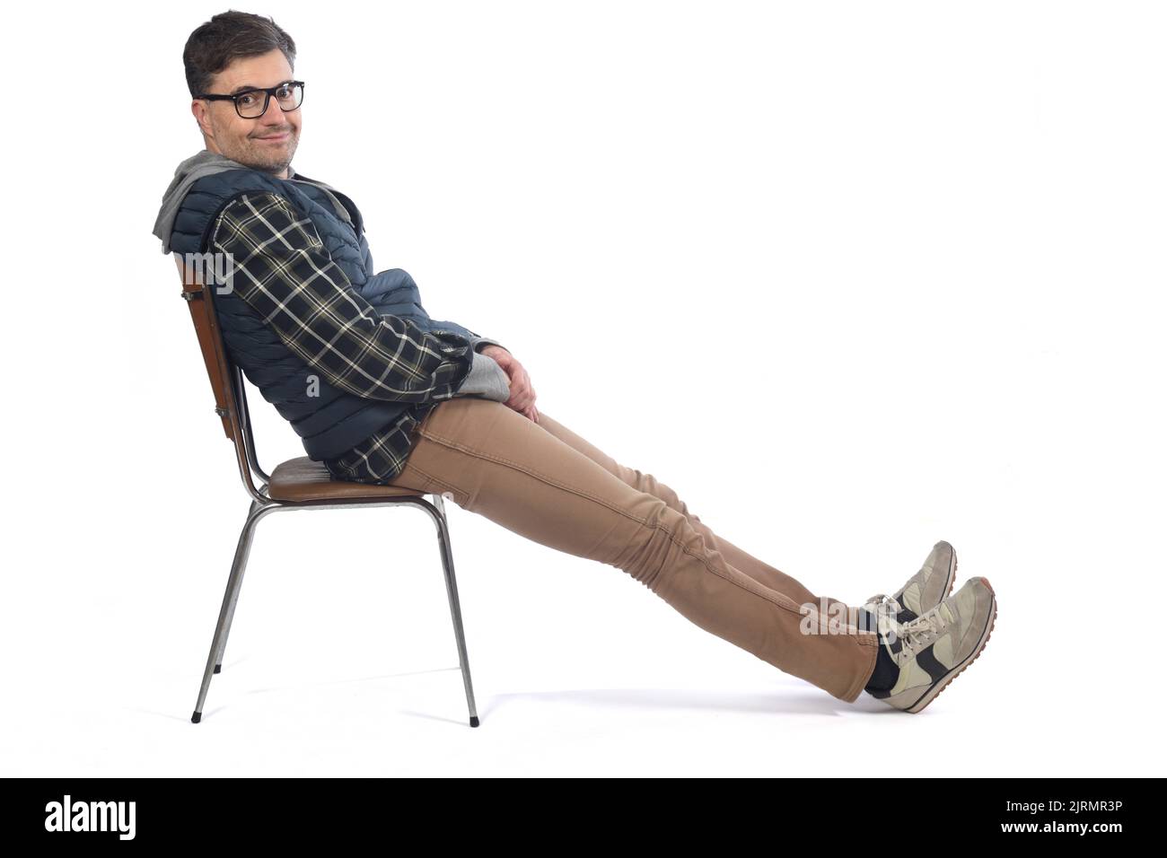 man sitting relaxed sitting on a chair looking at camera on white ...