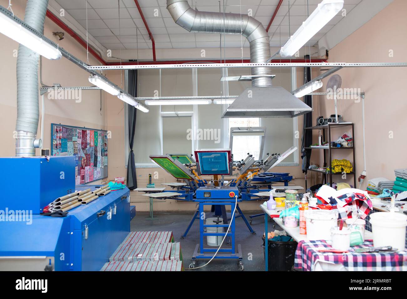 Serigraphy silk screen print process at clothes factory. Frame ...