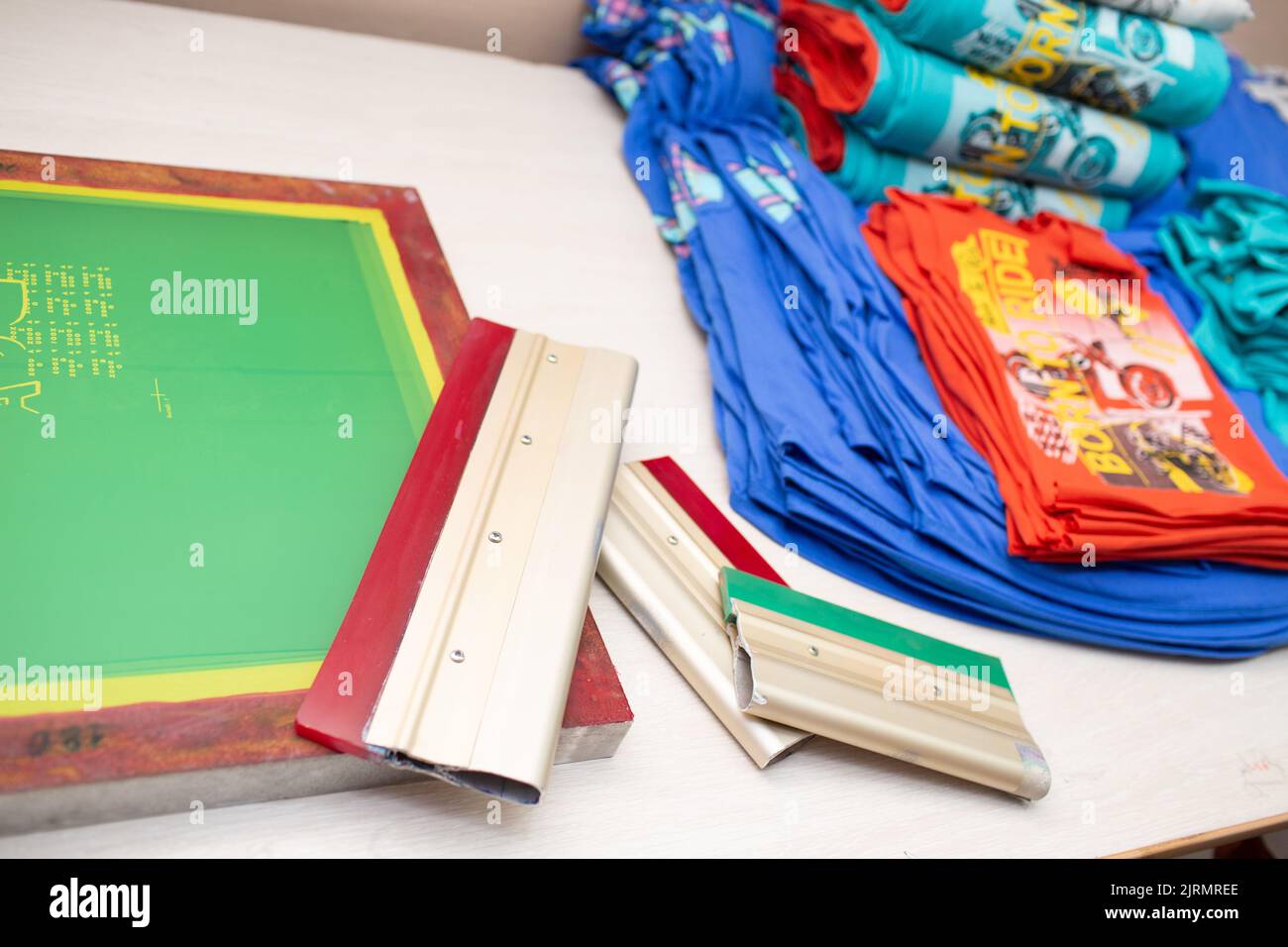 Serigraphy silk screen print process at clothes factory. Frame template ...