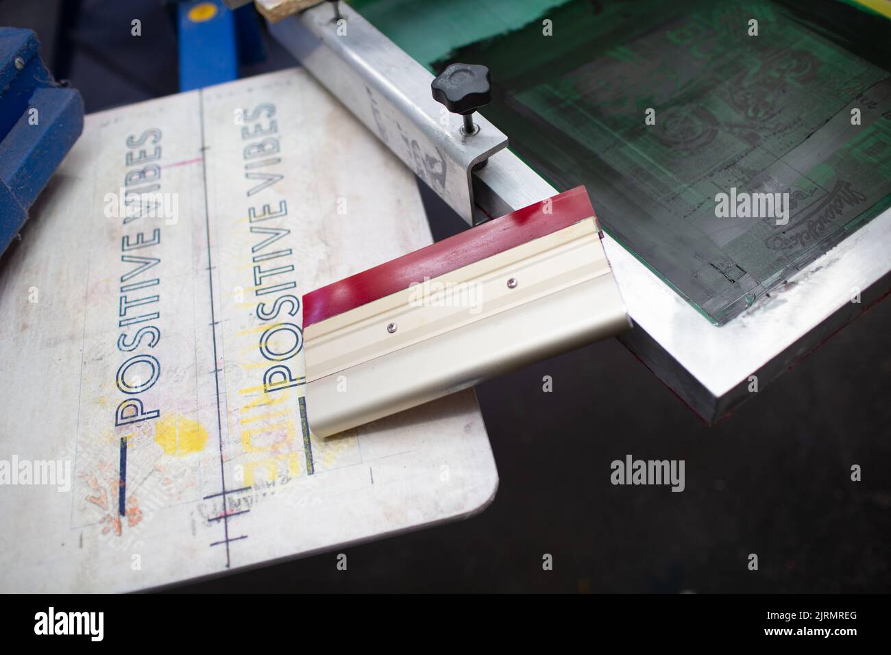 Serigraphy silk screen print process at clothes factory. Frame ...