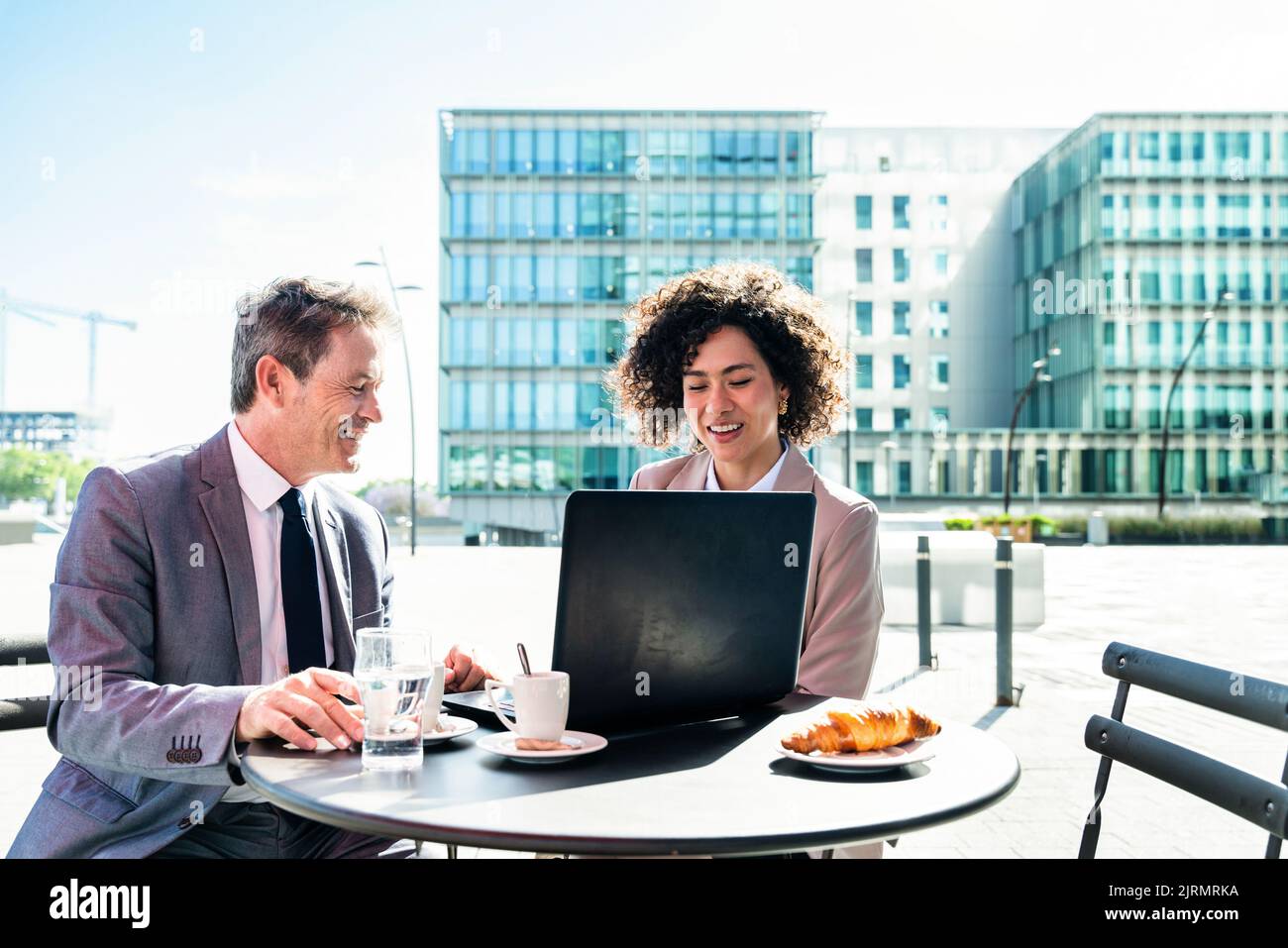 Senior businessman and beautiful hispanic businesswoman meeting in a ...