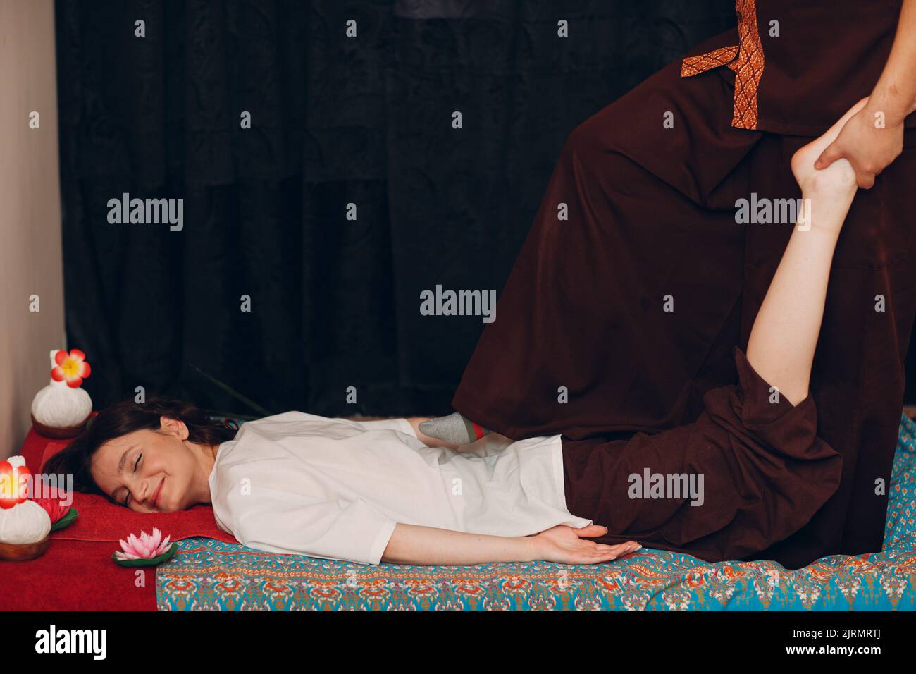 Thai man making classical thai massage procedure to young woman at ...