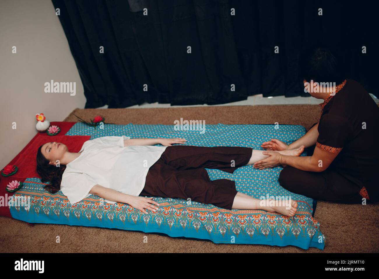 Thai man making classical thai massage procedure to young woman at ...