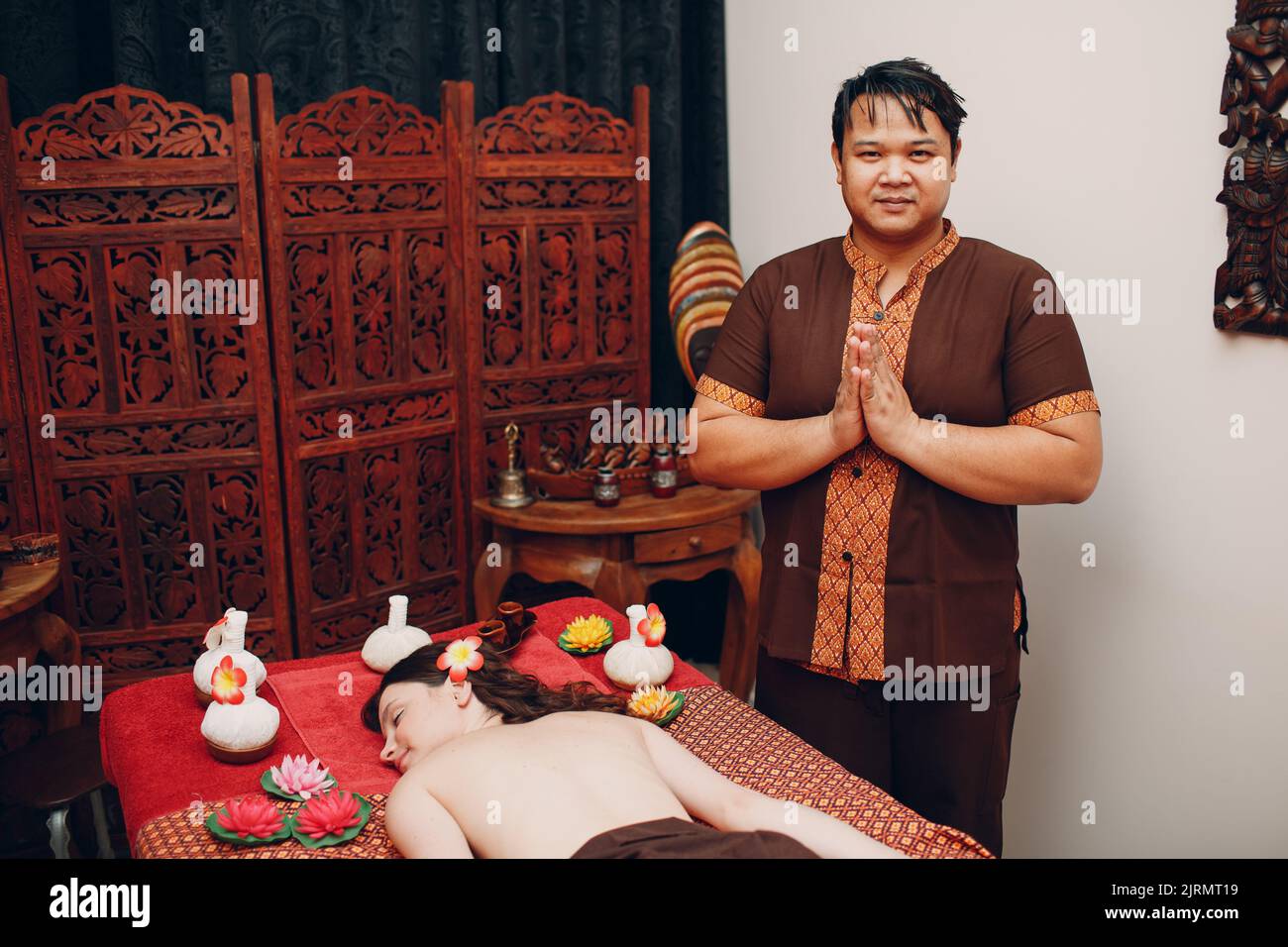 Thai man making classical thai massage procedure to young woman at ...