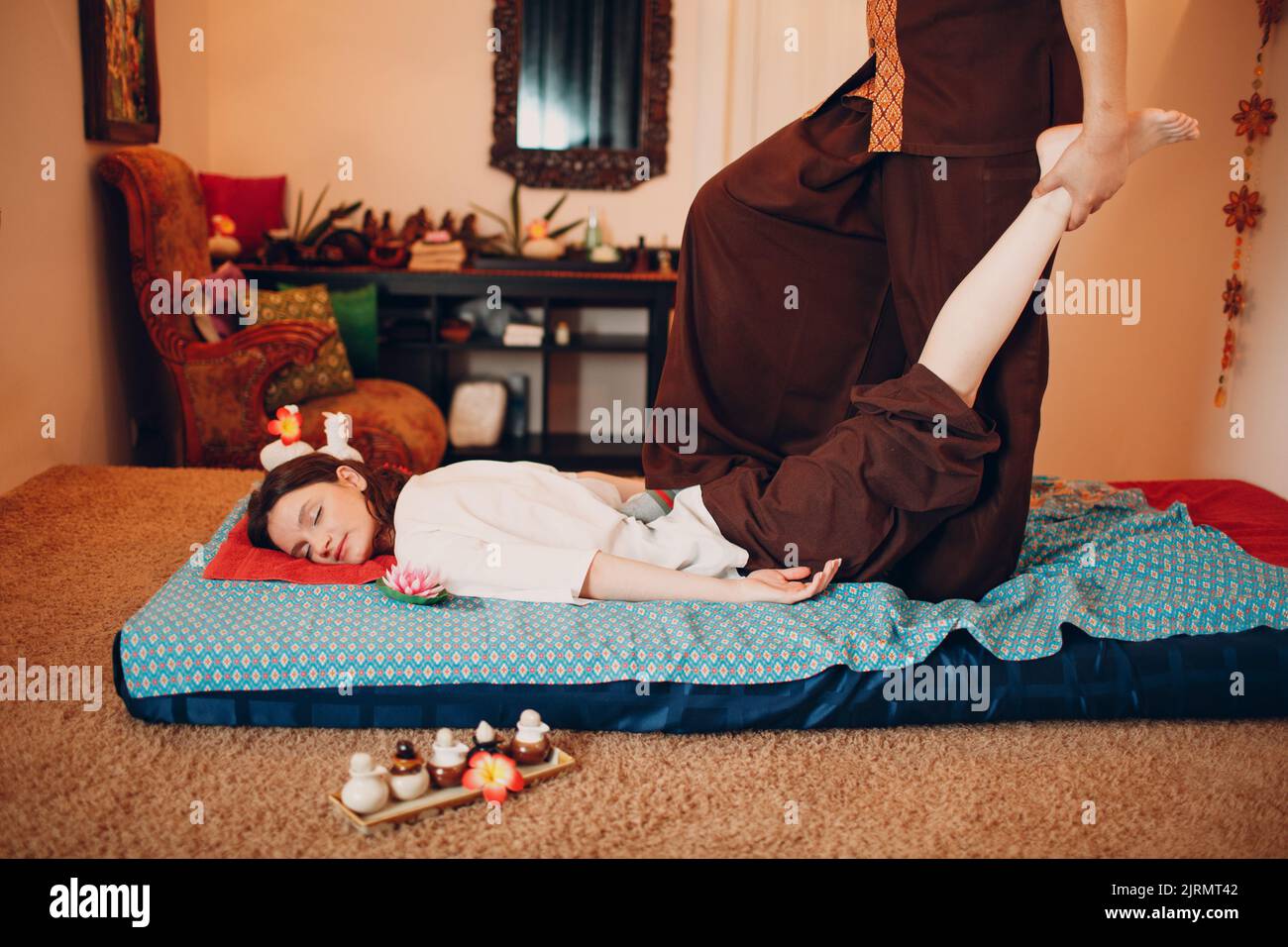 Thai man making classical thai massage procedure to young woman at ...
