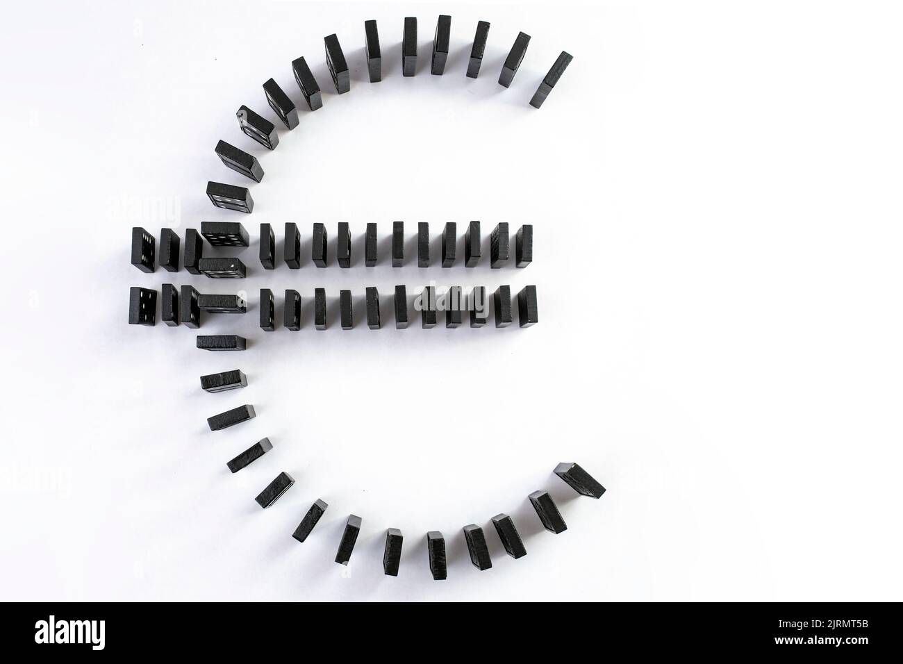 Euro currency symbol made from black domino tiles on white background ...