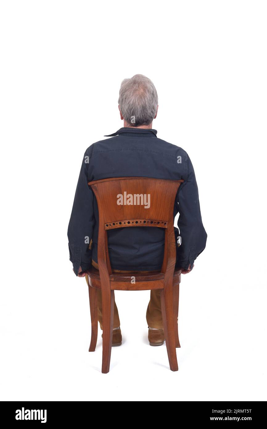 rear view of a man sitting on chair on white background Stock Photo - Alamy
