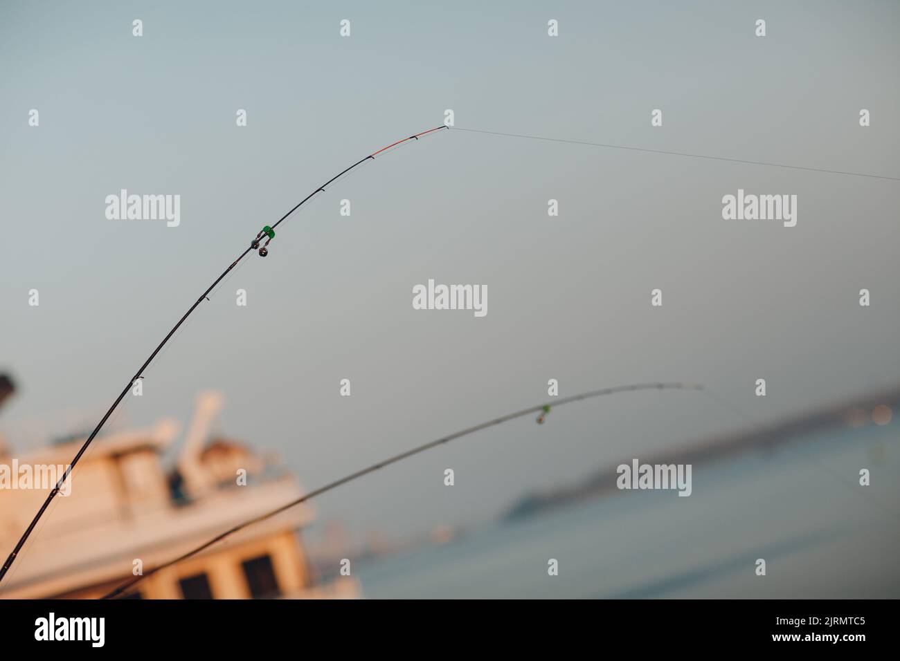 fishing rod and reel with fish in water Stock Photo - Alamy