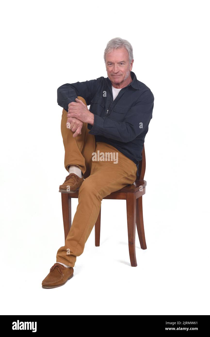 man sitting on chair with foot on the chair on white background Stock ...