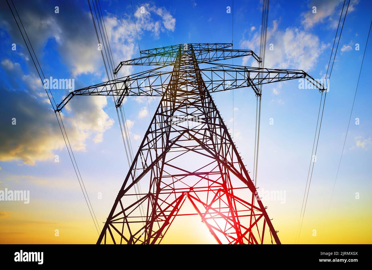 Electric pylon. Transmission tower with sunset sky at the background ...
