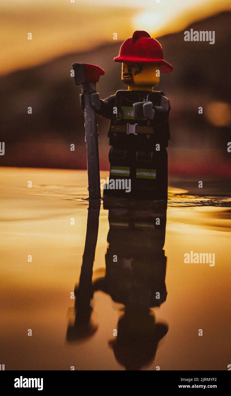A reflection of a Lego character during orange sunset Stock Photo - Alamy