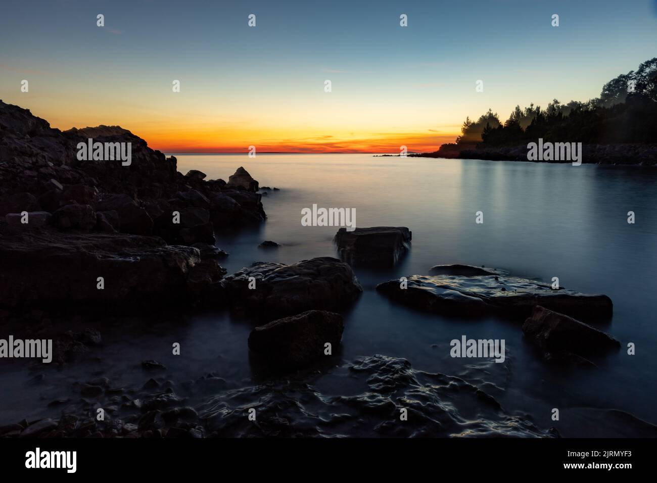 A beautiful view of a lake with a sunset sky in the background Stock ...