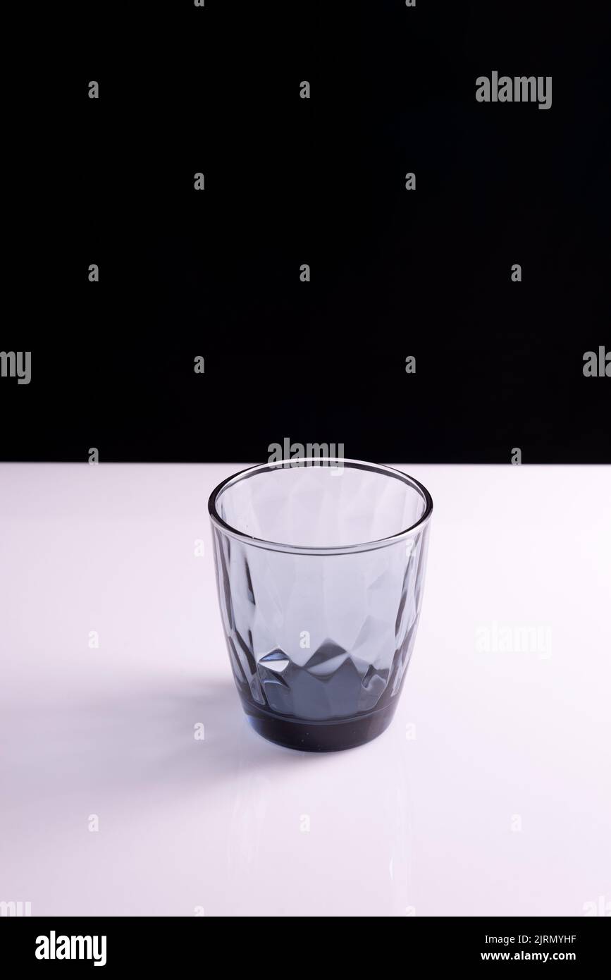 black glass beaker on a black white background. Minimalist Stock Photo ...