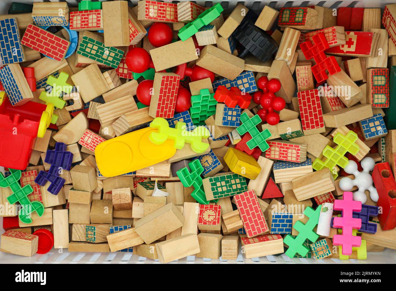 White plastic box with several toys in different colors and in ...