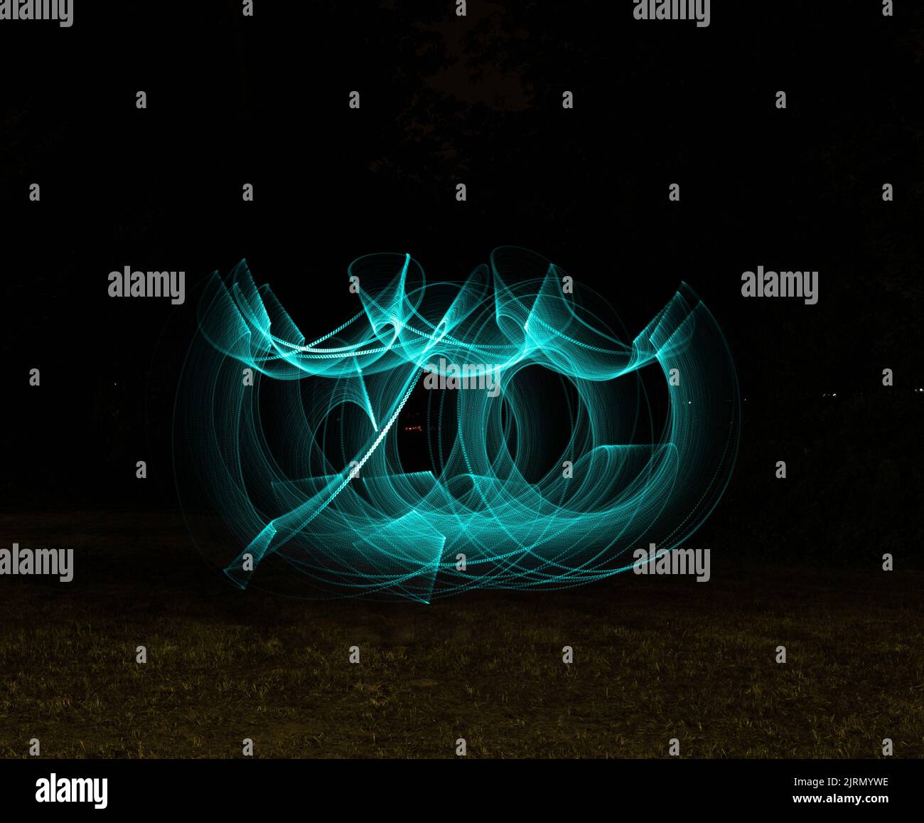 An illustrated blue abstract light painting on the background of a ...