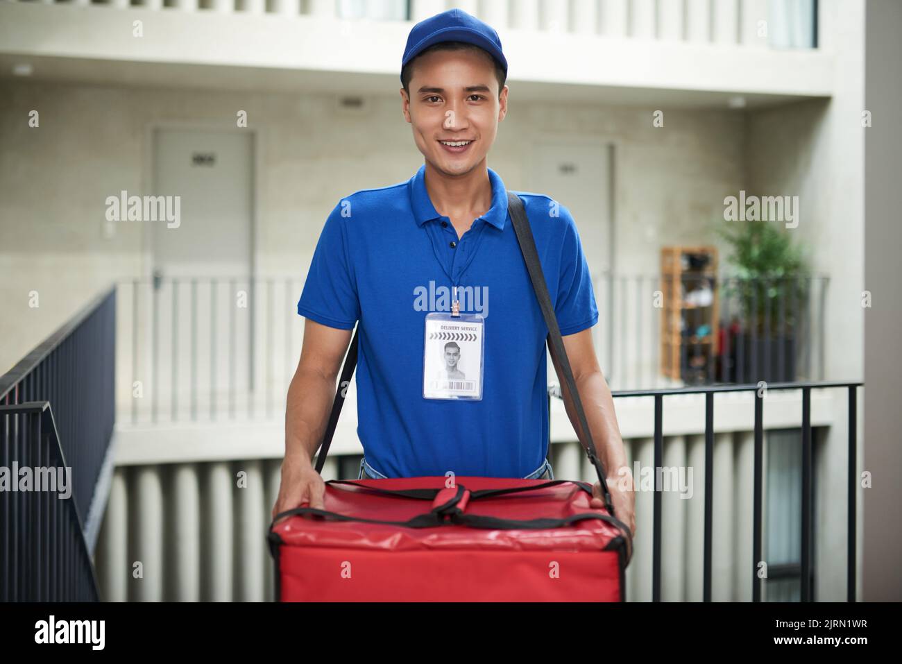 Young Asian delivery man with big bag of pizza Stock Photo - Alamy