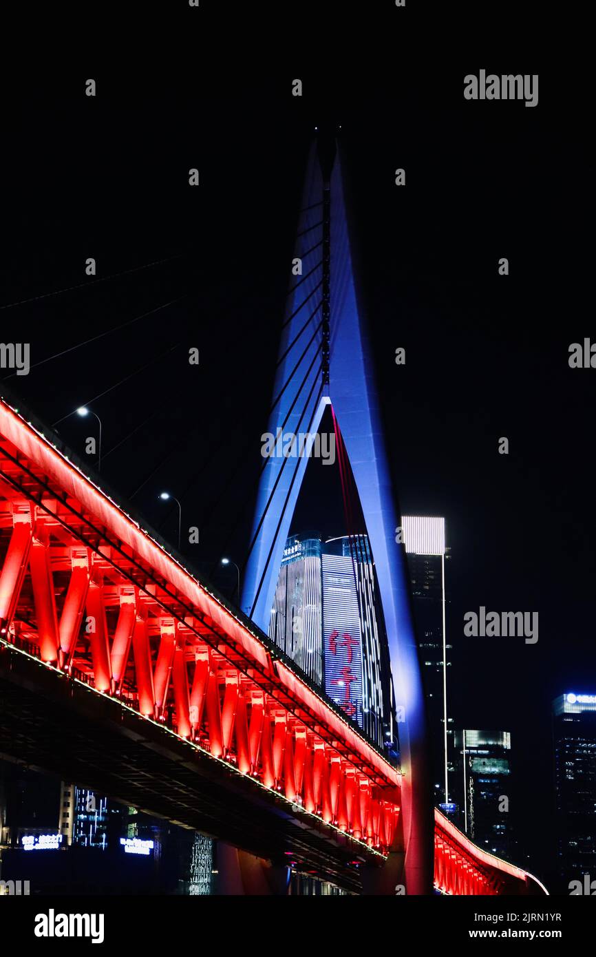 A vertical low angle shot of illuminated Chongqing Yangtze River Bridge ...